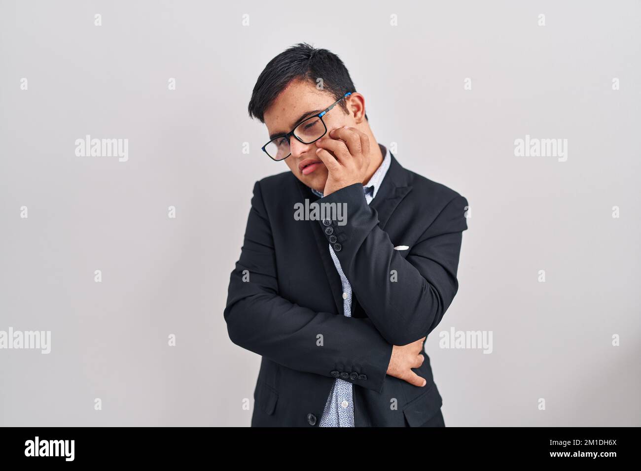 Young hispanic man with down syndrome wearing business style thinking ...