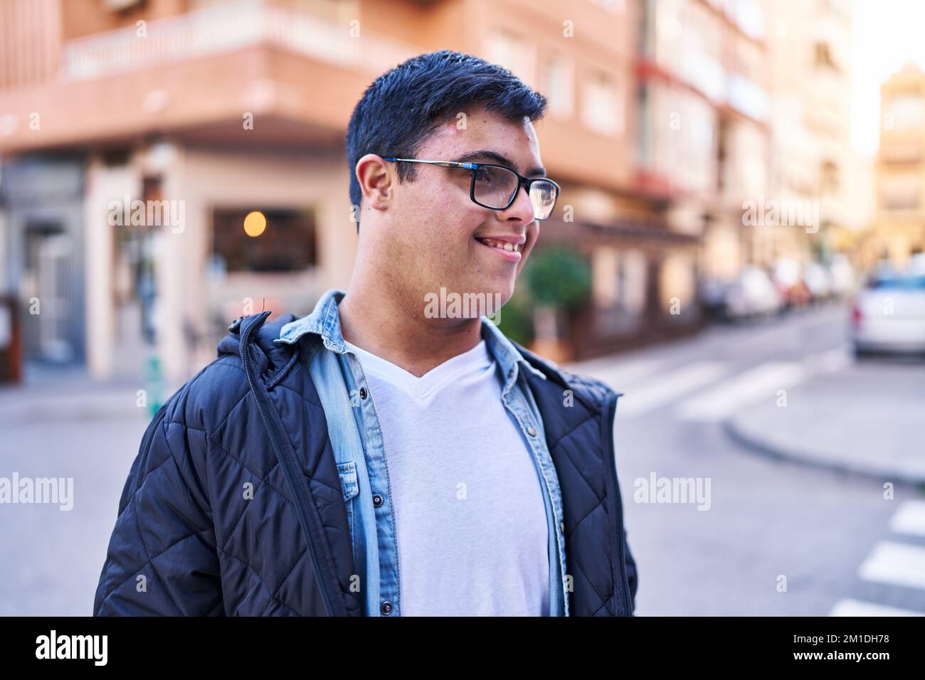 Down syndrome man smiling confident standing at street Stock Photo - Alamy