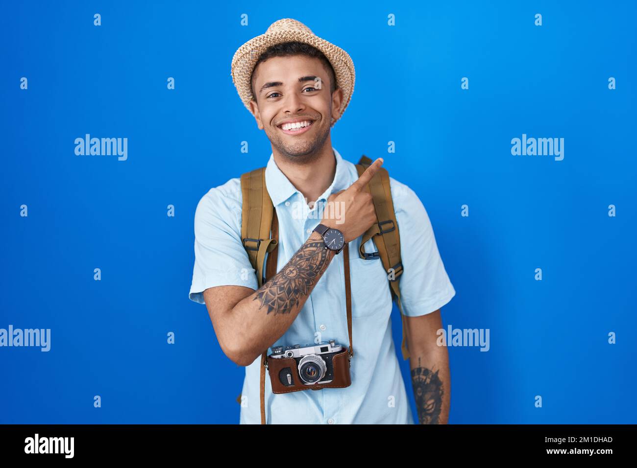 Brazilian young man holding vintage camera cheerful with a smile of ...