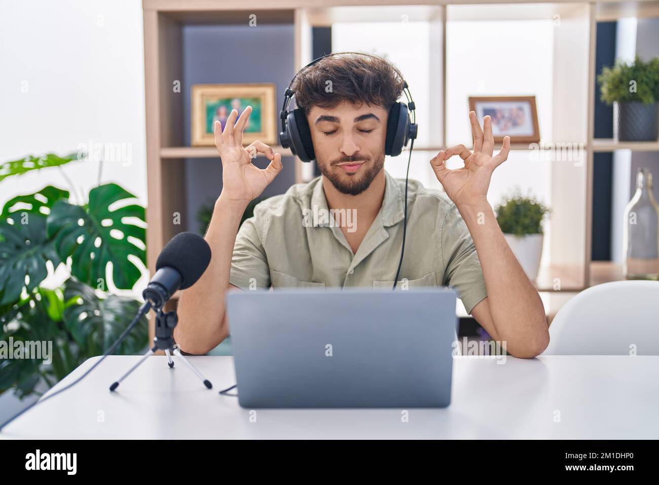 Arab man with beard working at the radio relax and smiling with eyes ...