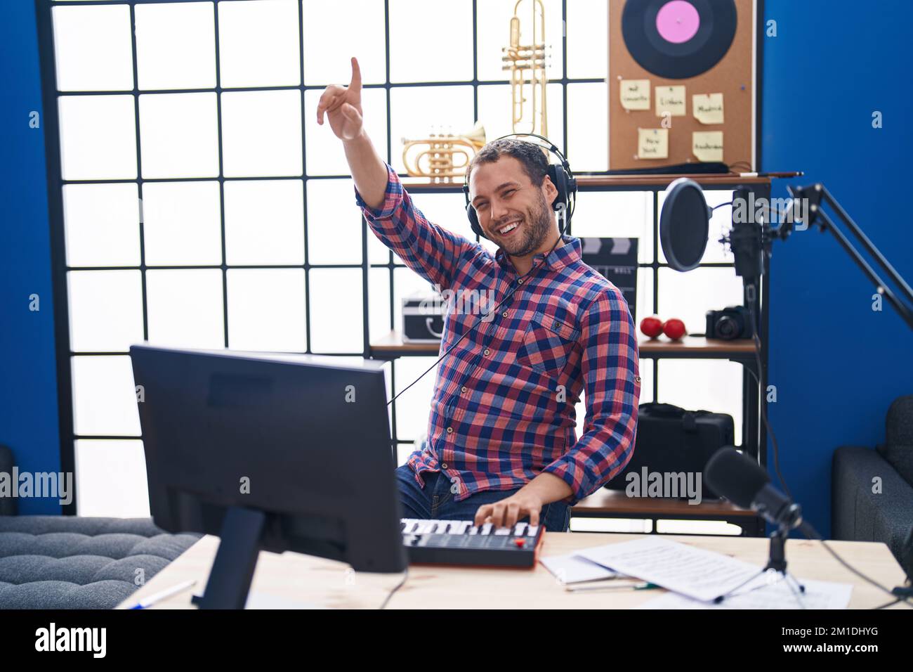 Young man musician having dj session at music studio Stock Photo - Alamy