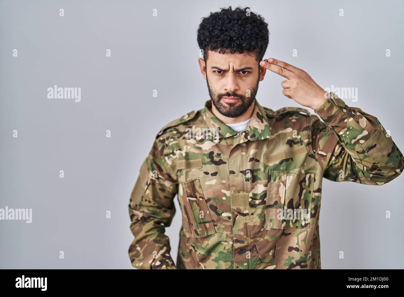 Arab man wearing camouflage army uniform shooting and killing oneself ...