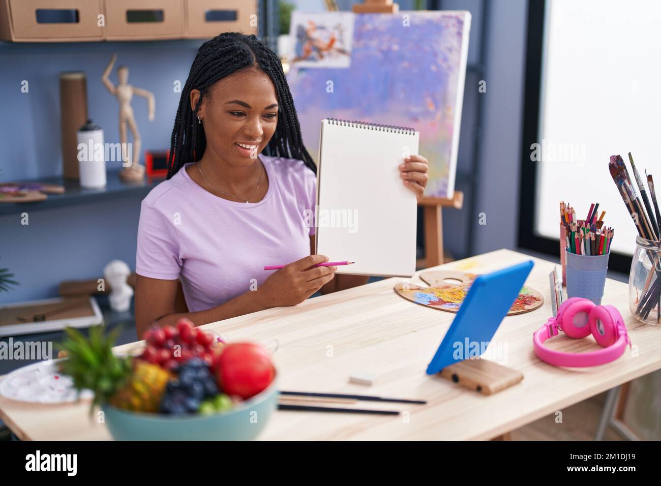 African american woman artist having online draw class at art studio ...