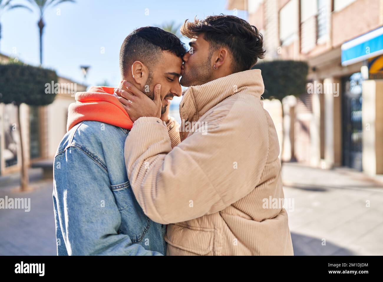Two man couple hugging each other standing at street Stock Photo - Alamy
