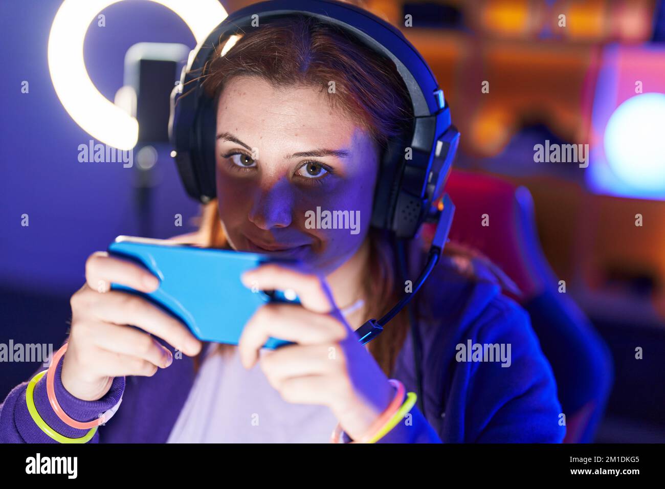 Young beautiful plus size woman streamer playing video game using ...