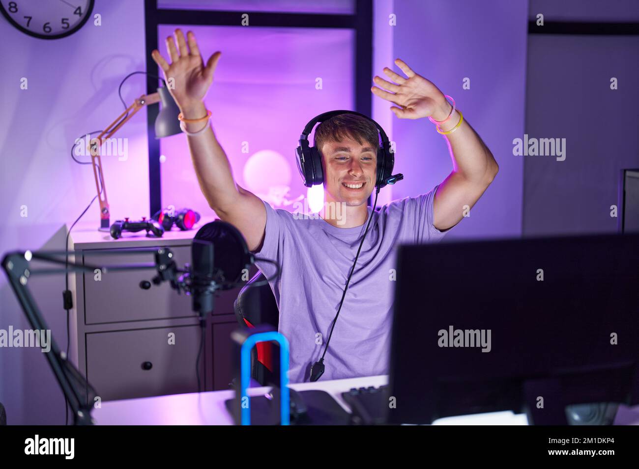 Young caucasian man streamer playing video game with winner expression ...