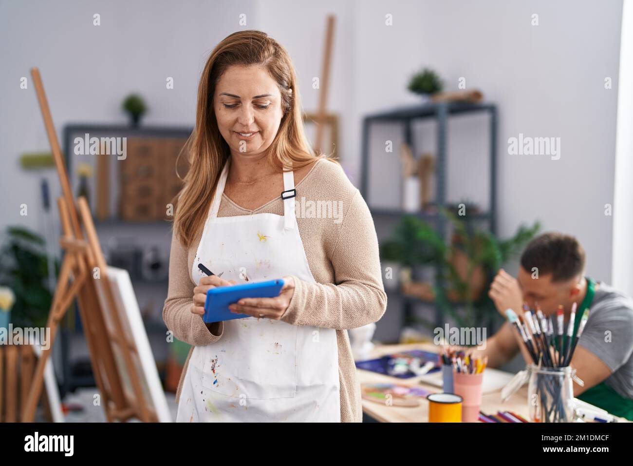 Man and woman artists drawing on notebook using touchpad at art studio ...