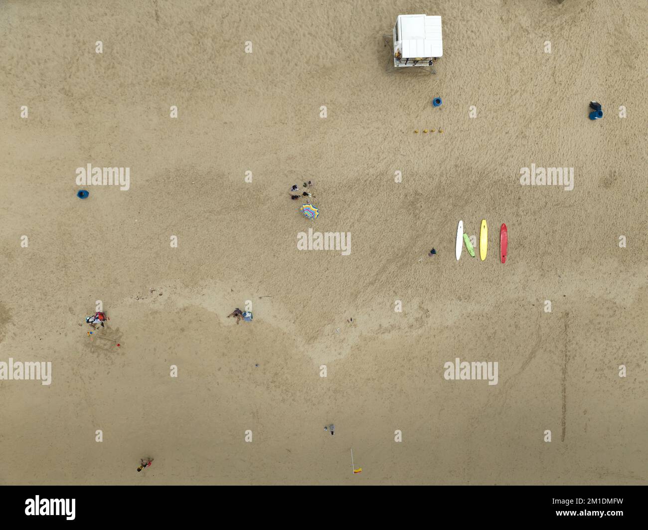 People seen sitting on sand at beach Stock Photo - Alamy