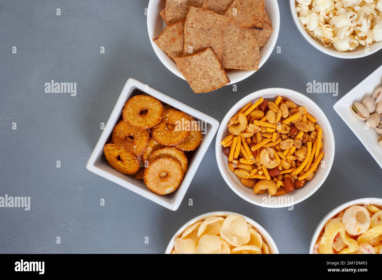 Party snacks, an assortment on gray with copy space Stock Photo - Alamy