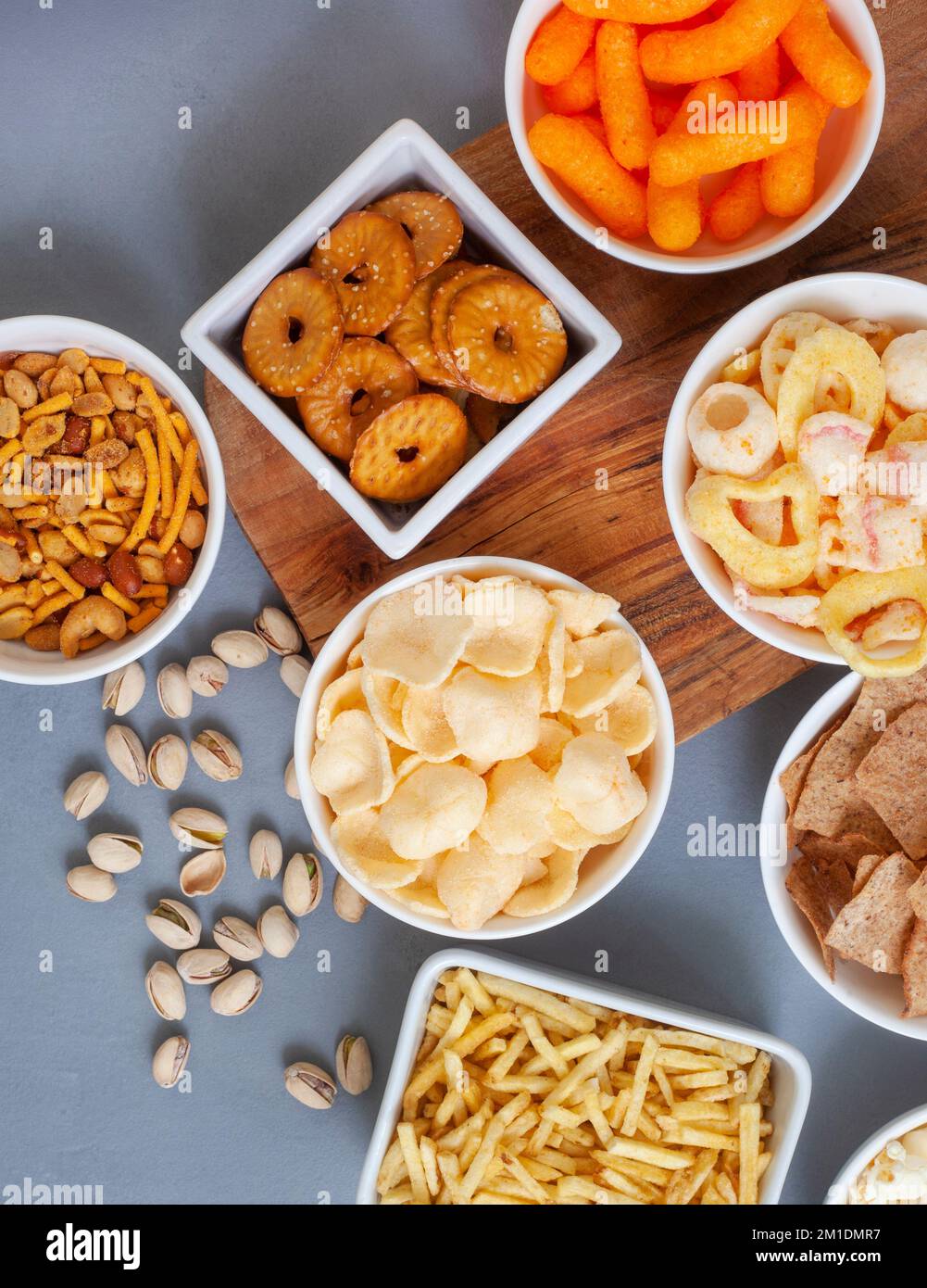 Party snacks, an assortment on gray with copy space Stock Photo - Alamy