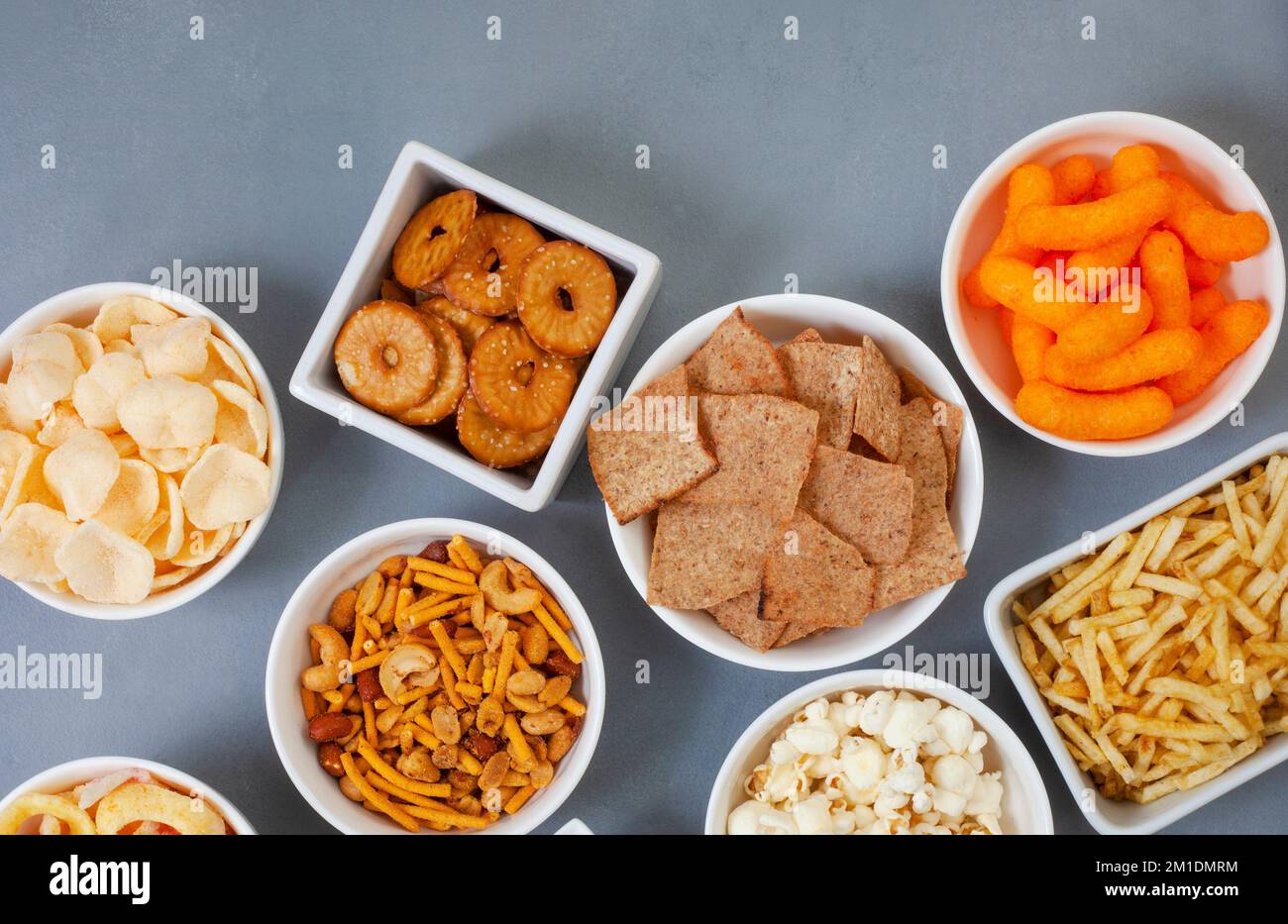 Party snacks, an assortment on gray with copy space Stock Photo - Alamy