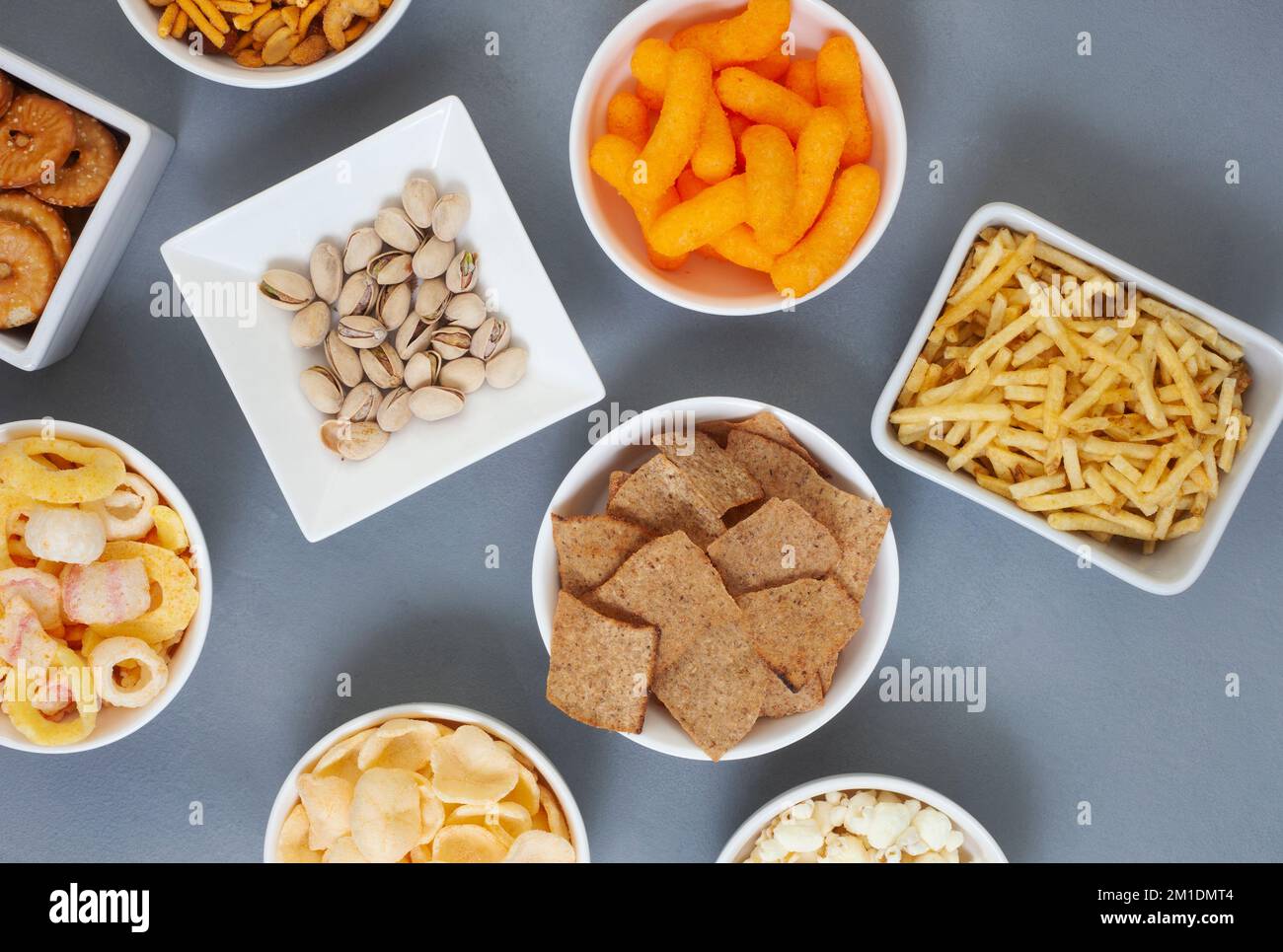 Party snacks, an assortment on gray with copy space Stock Photo - Alamy