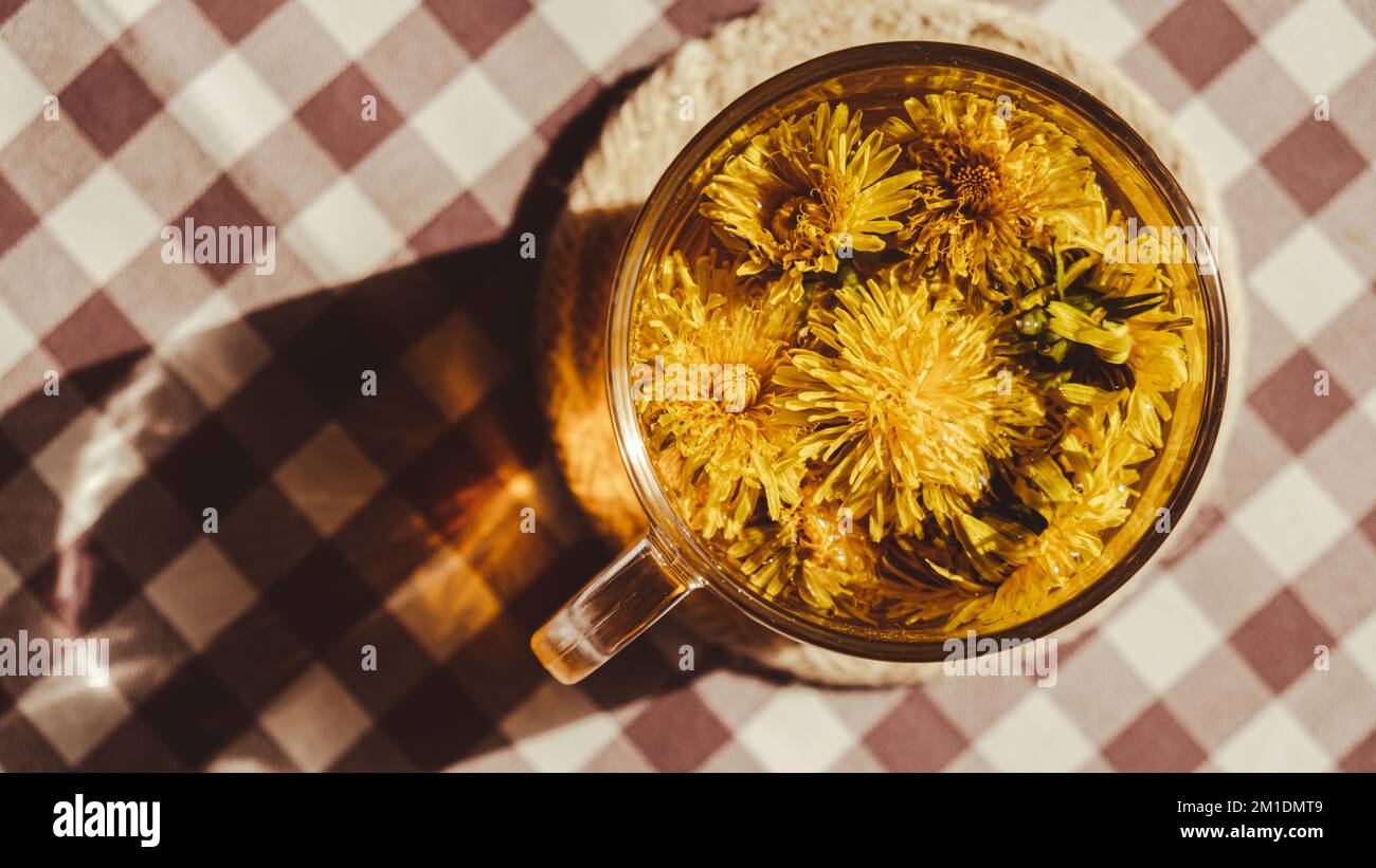 Dandelion flower healthy tea in glass cup on table. Herbal medicine ...