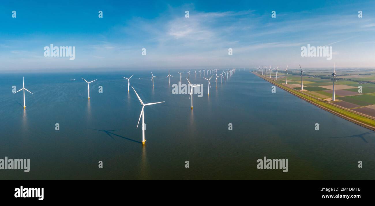 Drone Aerial view at Windmill park with windmills turbines in the ocean ...