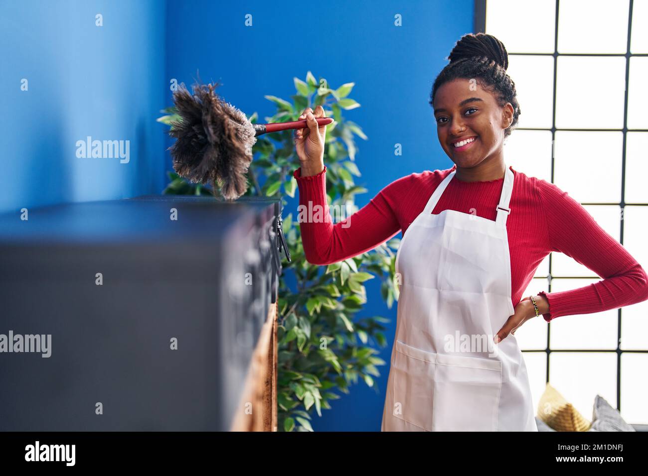 African american woman smiling confident cleaning dust at home Stock ...