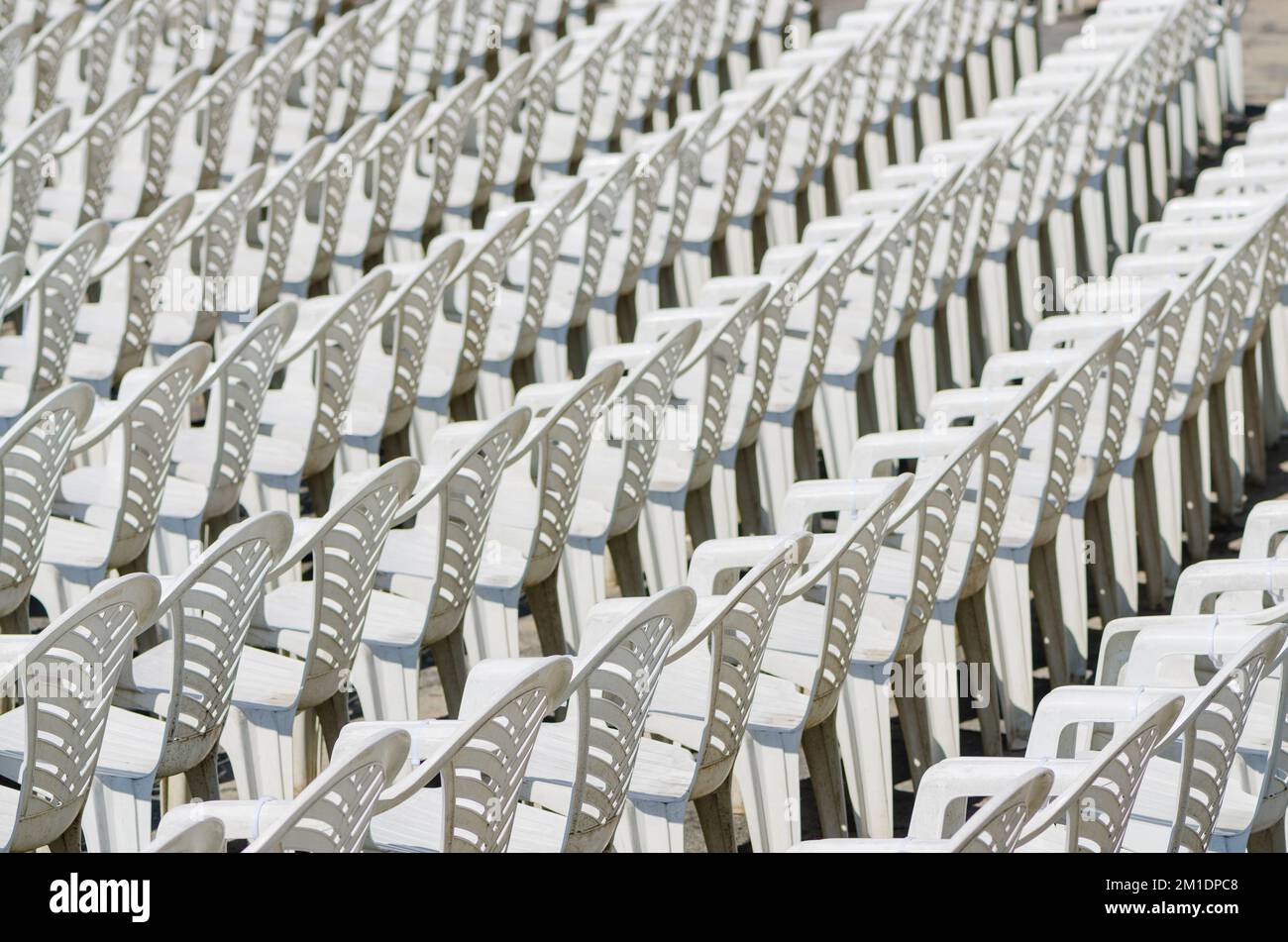 White plastic chairs arranged in rows in an open air concert area Stock ...