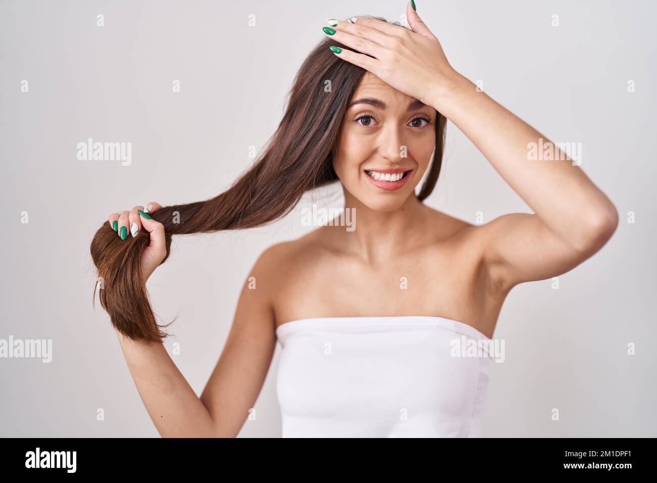 Young hispanic woman holding hair with hand stressed and frustrated ...