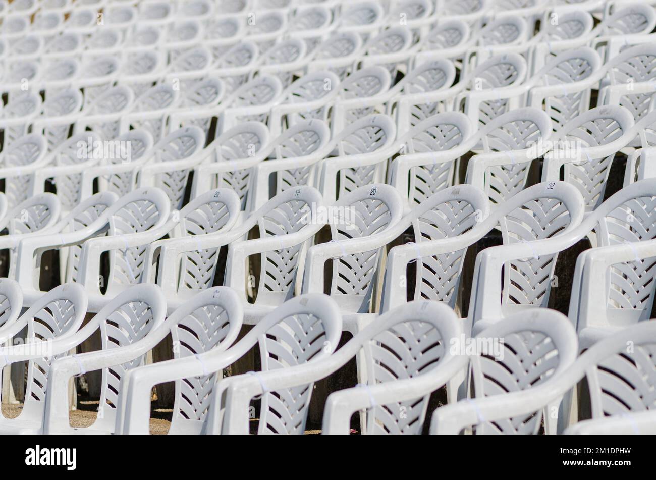 White plastic chairs arranged in rows in an open air concert area Stock ...