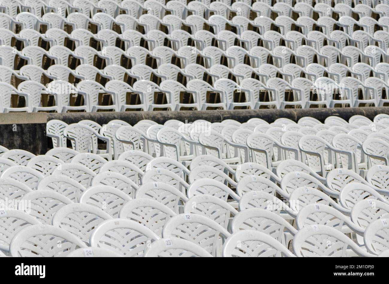 White plastic chairs arranged in rows in an open air concert area Stock ...