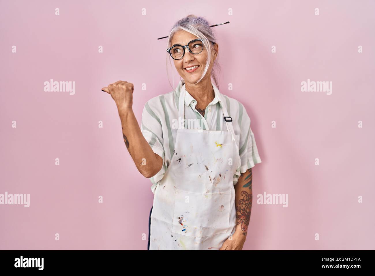 Middle age woman with grey hair wearing artist look smiling with happy ...