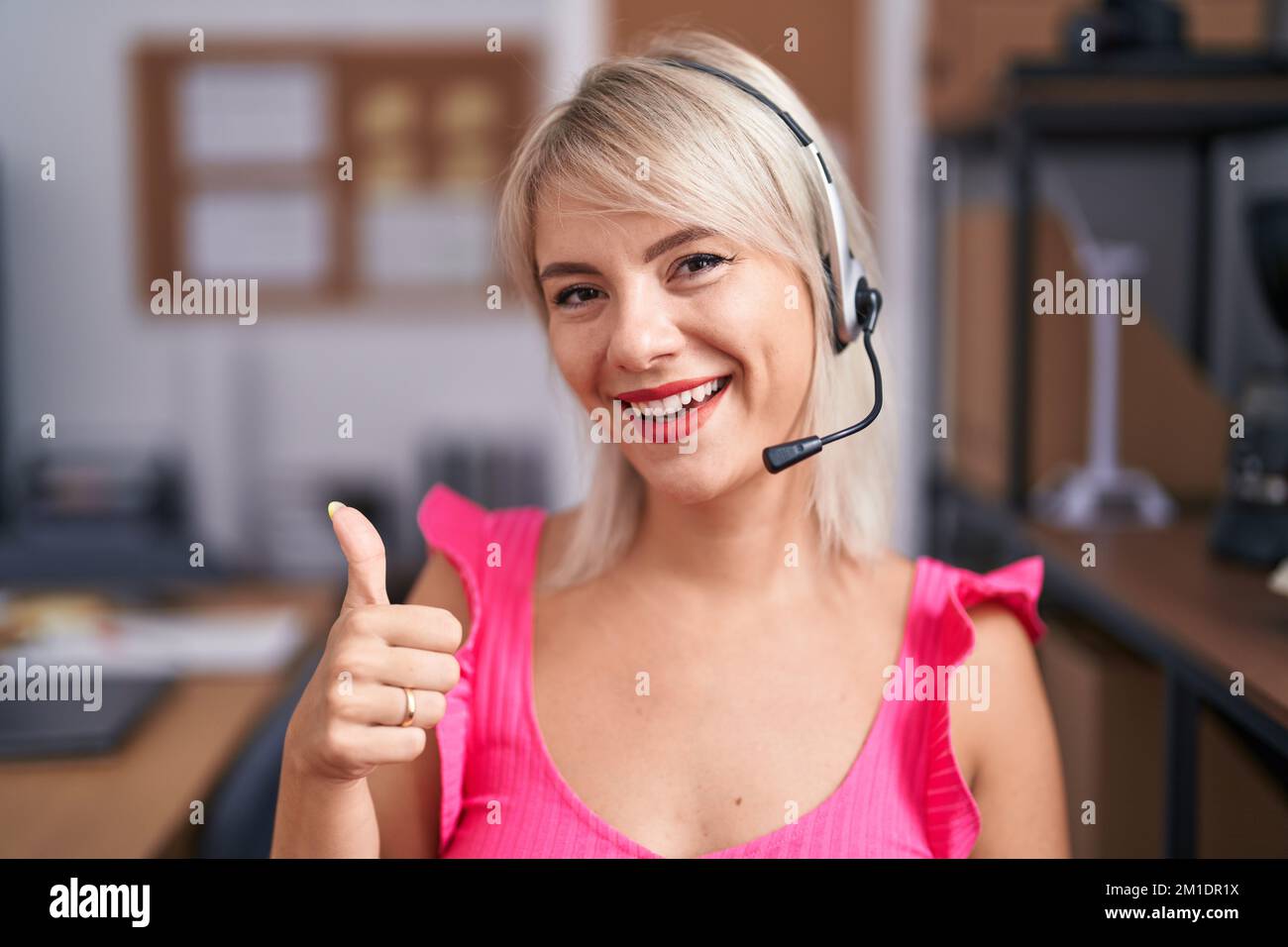 Young caucasian woman wearing call center agent headset smiling happy ...