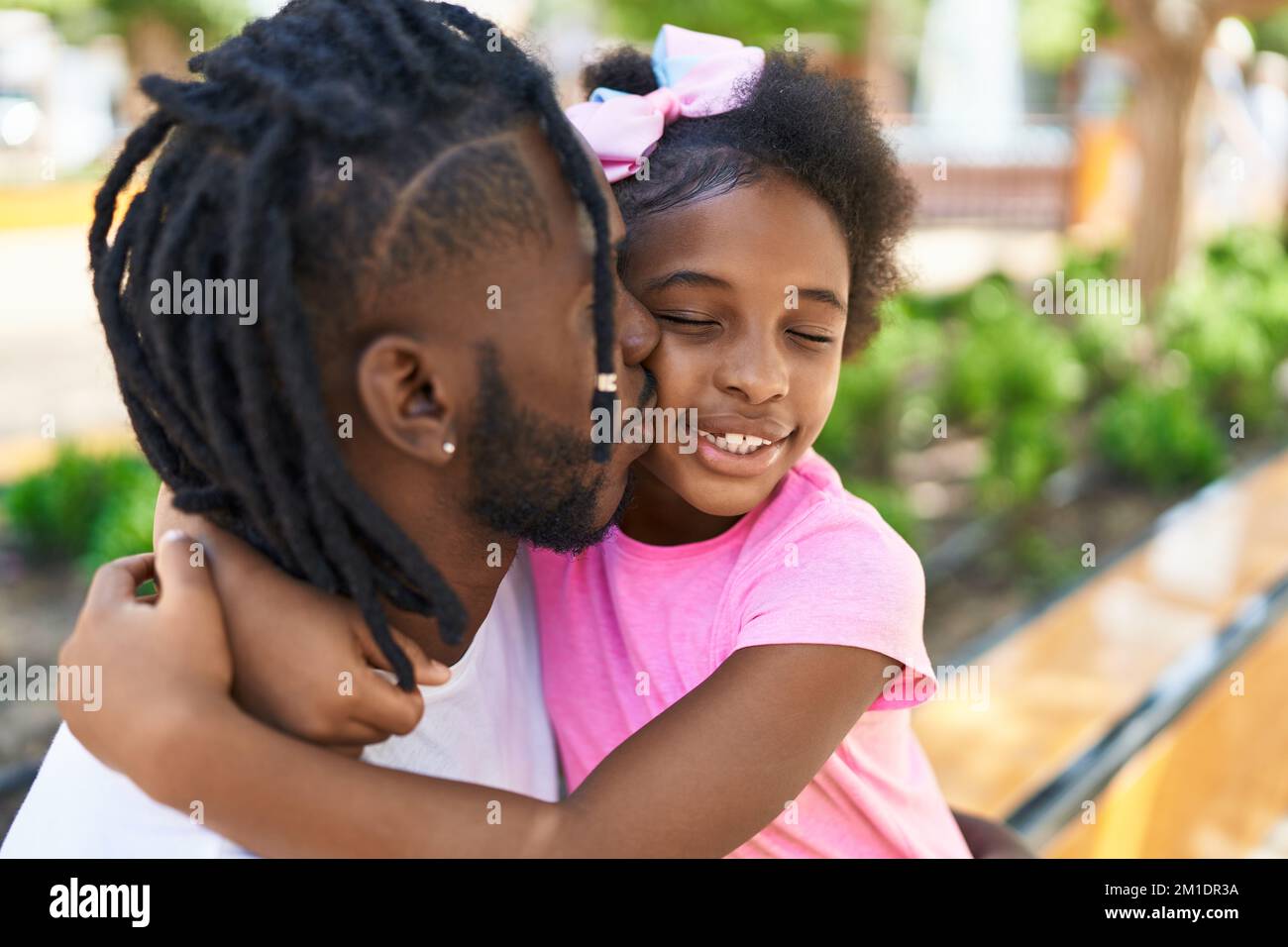 Father and daughter smiling confident hugging each other and kissing at park Stock Photo - Alamy