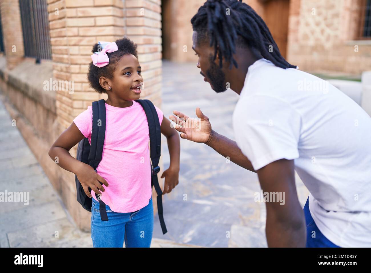 Father and daughter standing together speaking at school Stock Photo ...