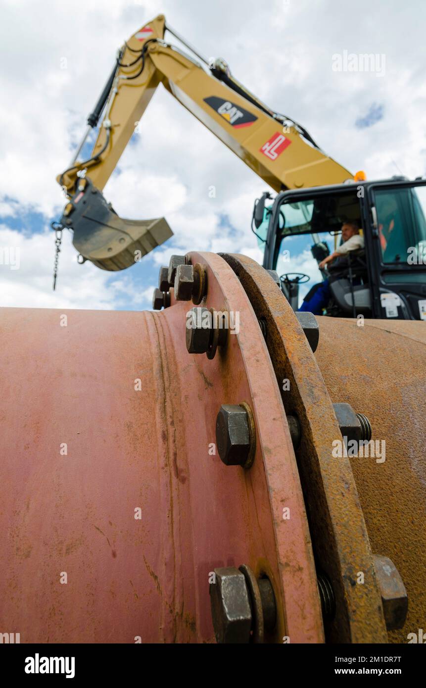 Flange of a drain pipe with a shovel excavator in the back Stock Photo ...