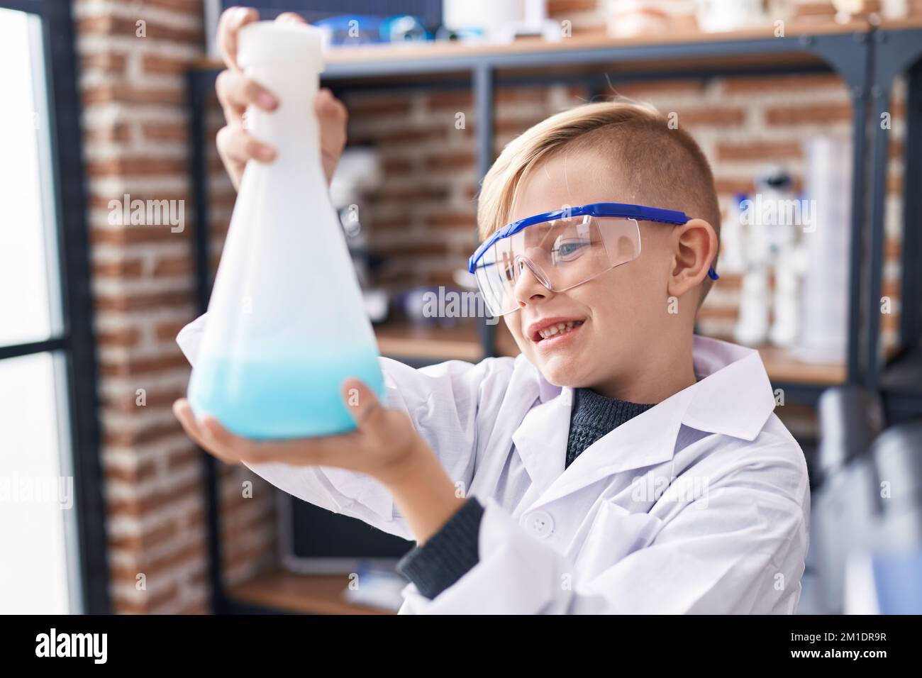 Adorable toddler student holding test tube at classroom Stock Photo - Alamy
