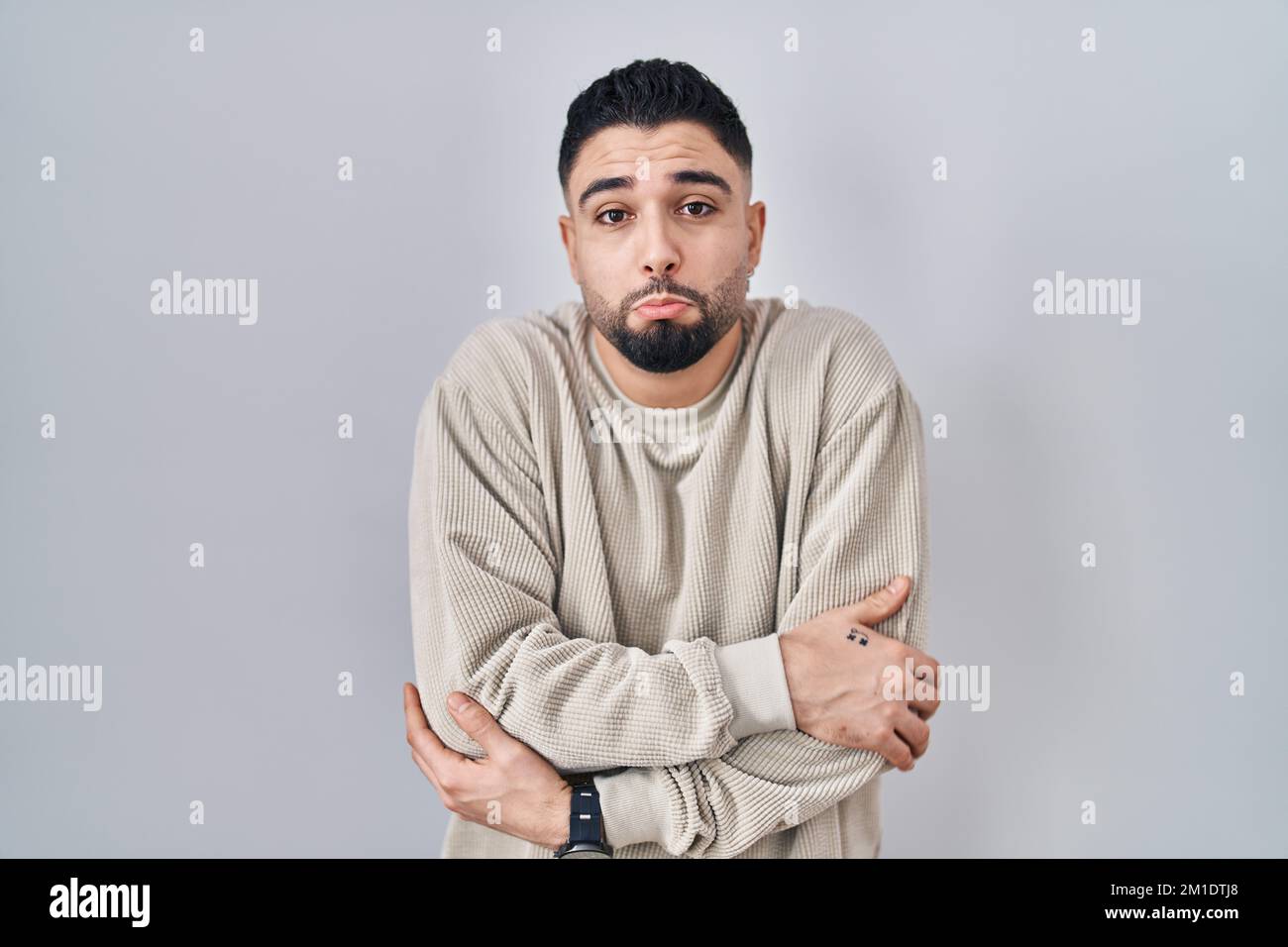 Young handsome man standing over isolated background shaking and ...