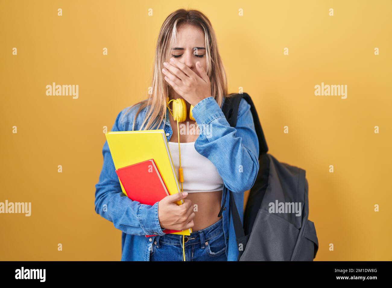 Young blonde woman wearing student backpack and holding books bored ...