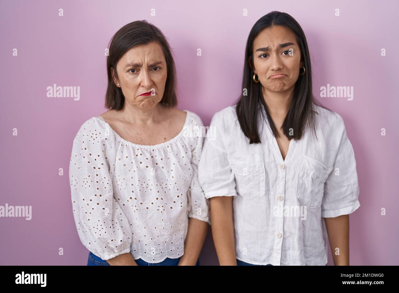 Hispanic mother and daughter together depressed and worry for distress ...