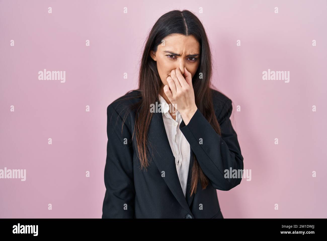 Young brunette woman wearing business style over pink background ...