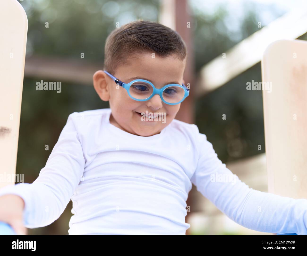 Adorable hispanic toddler smiling confident playing on slide at park playground Stock Photo - Alamy