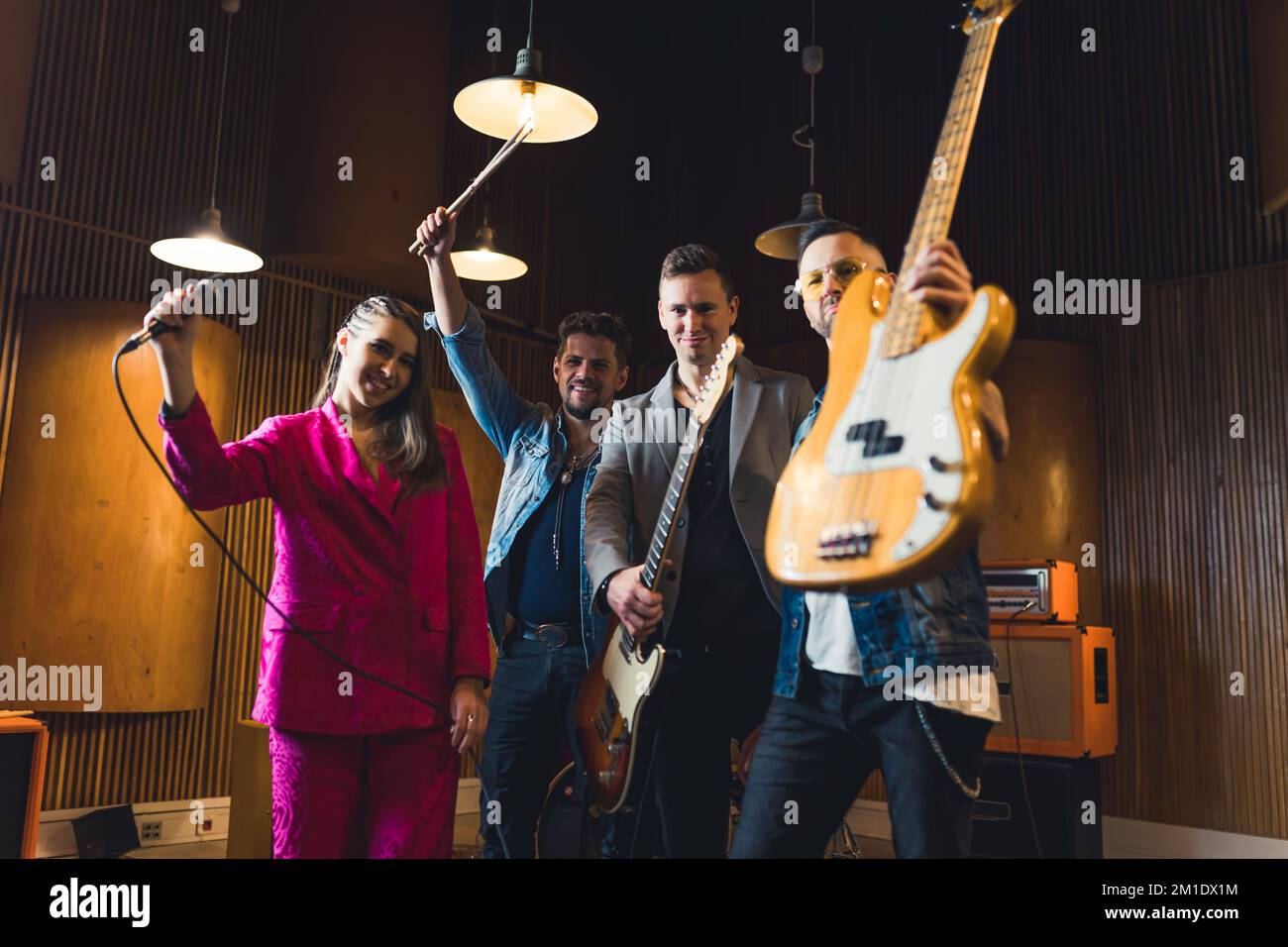 Happy band members with their instruments. Caucasian woman standing ...