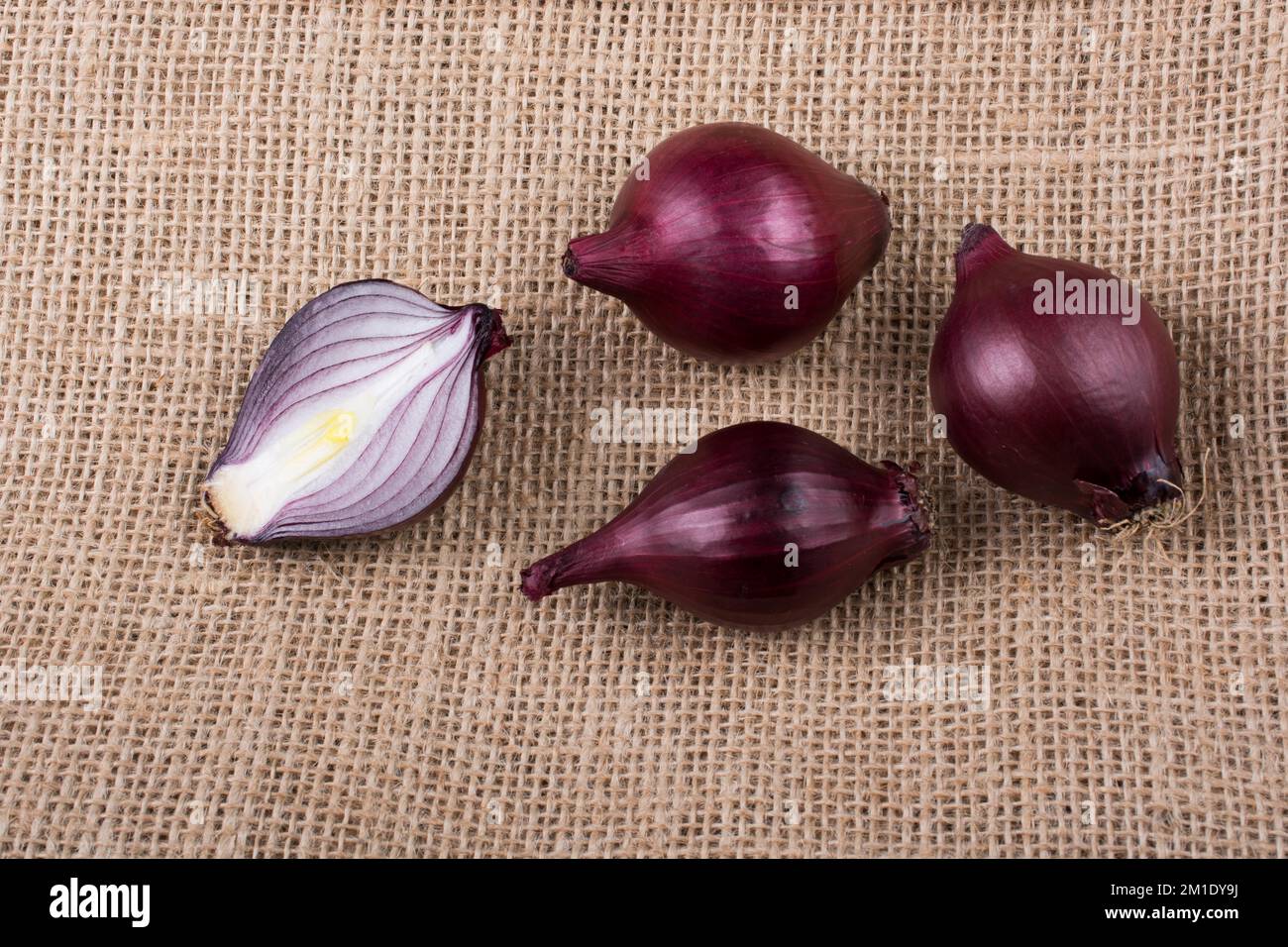 Red onion bulb cut in half on a certain background Stock Photo - Alamy