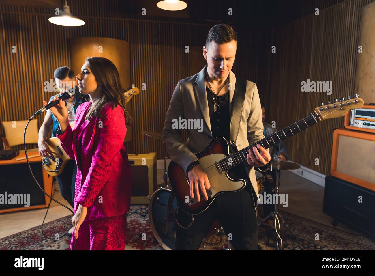 Musicians in recording studio. Process of creating a music album. Group ...