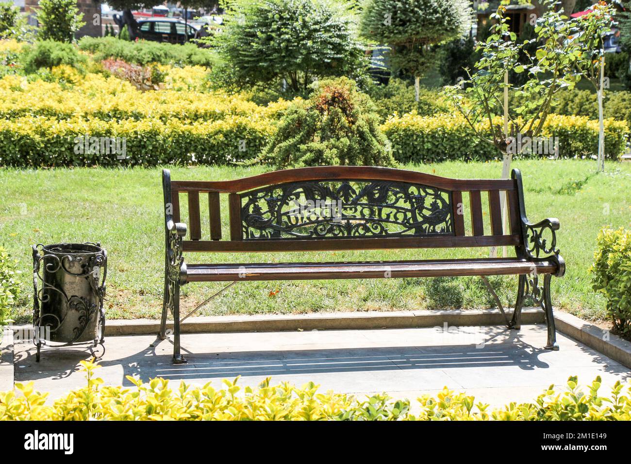 Wooden park bench at a park Stock Photo - Alamy