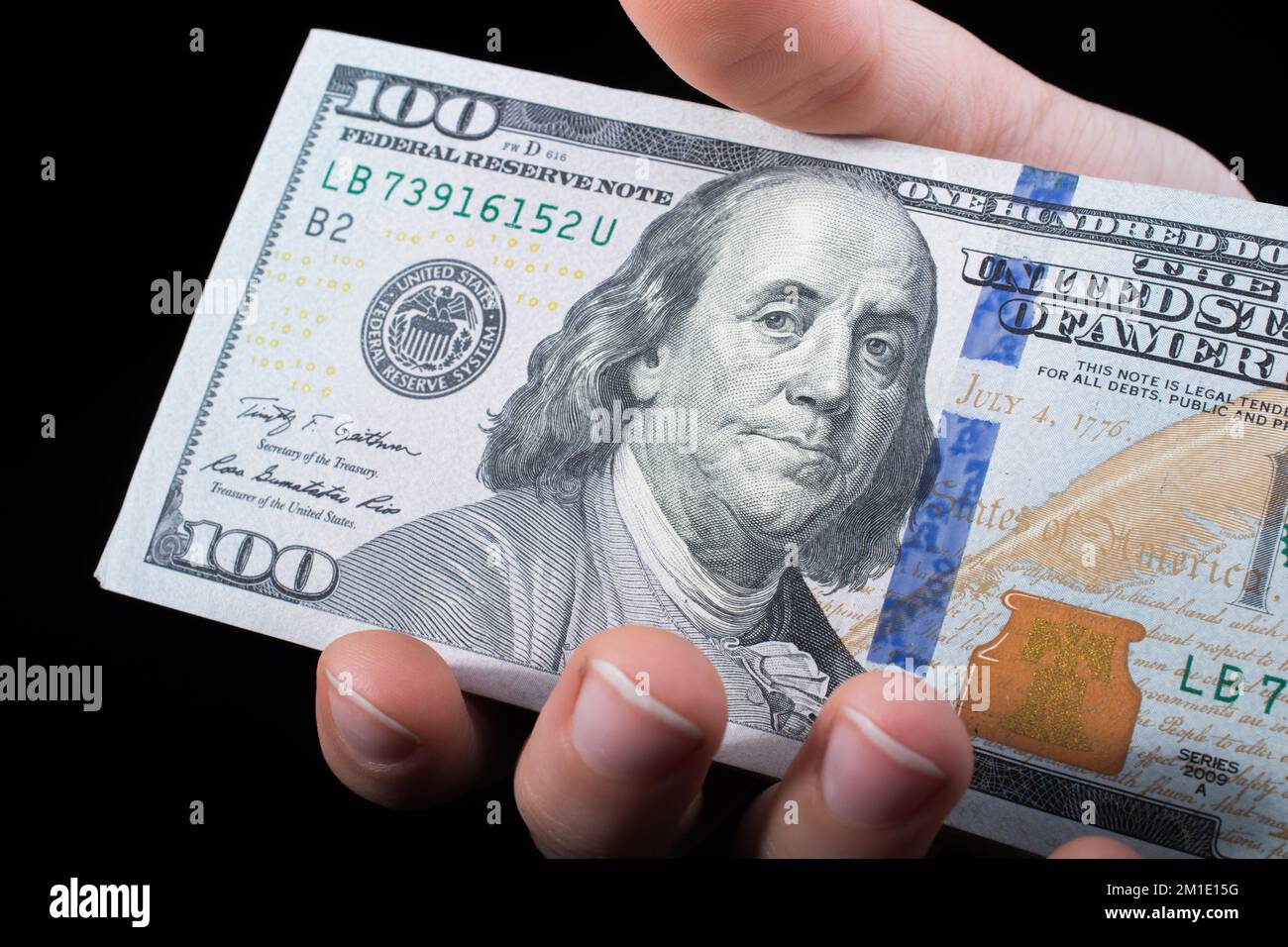 Hand holding American dollar banknotes isolated on white background ...