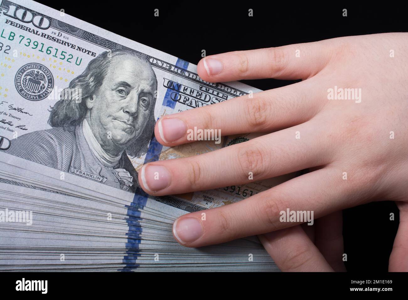 Hand holding American dollar banknotes isolated on white background ...