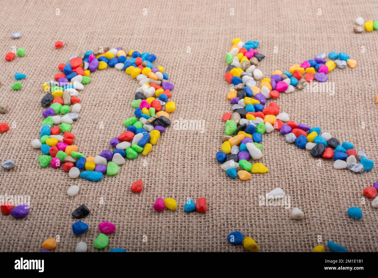 Colorful pebbles form the word OK on canvas ground Stock Photo - Alamy