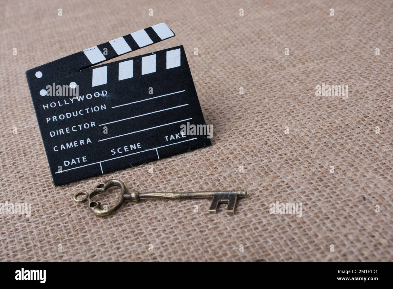Movie clapper and retro key on canvas background Stock Photo - Alamy