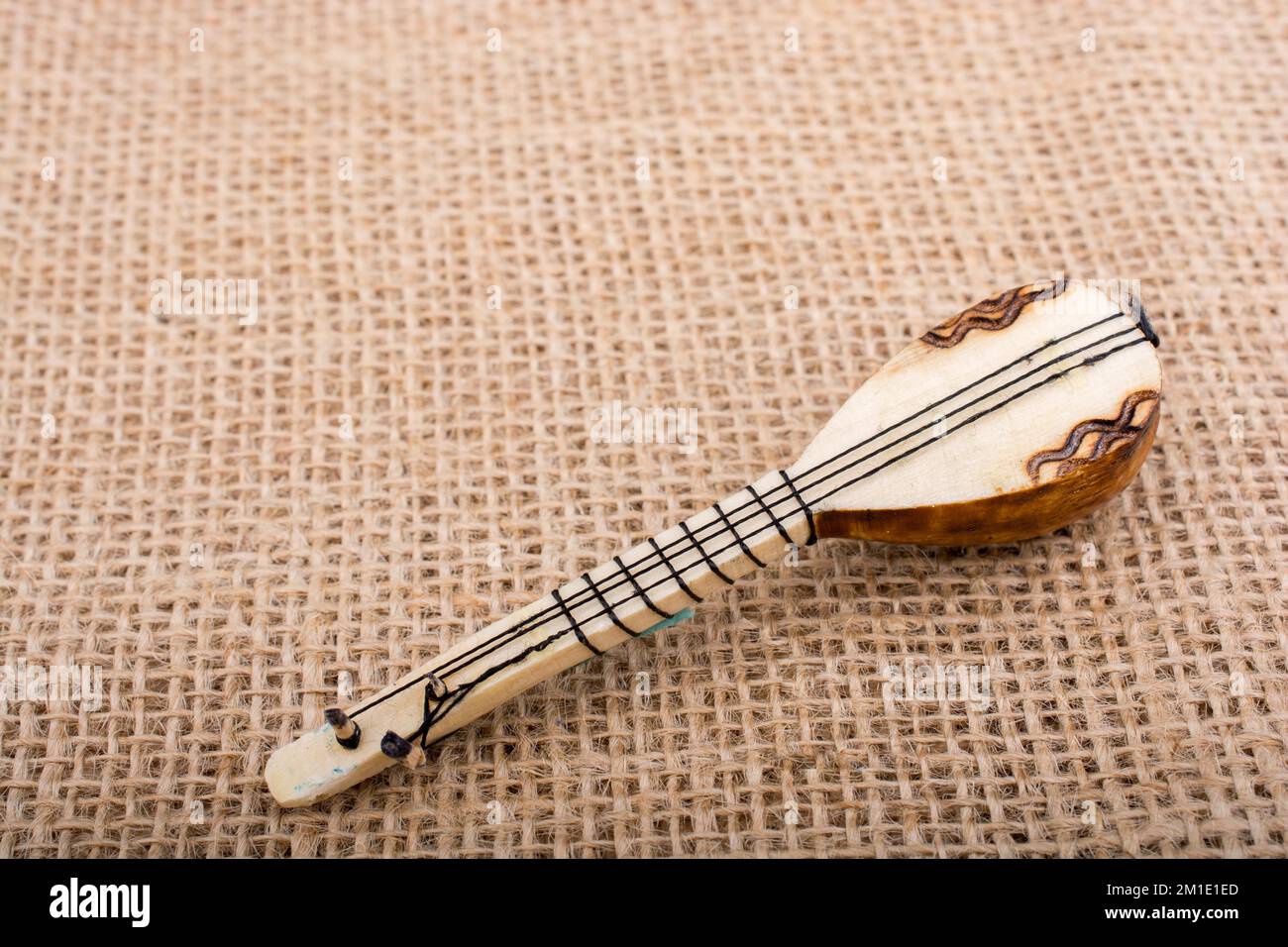 Model of Turkish musical instrument saz on a linen canvas Stock Photo ...
