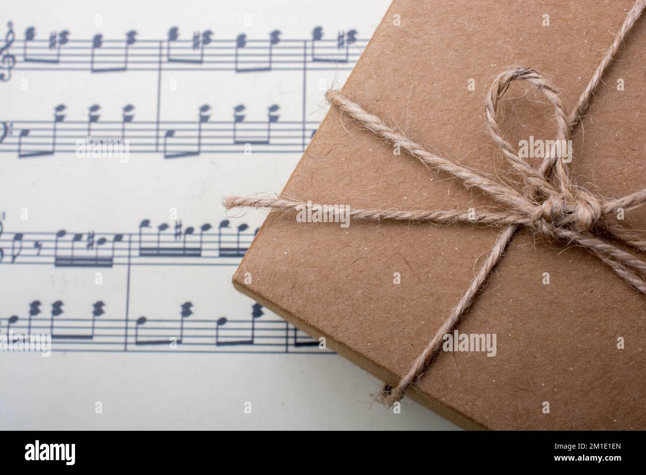 Gift box placed on a paper with musical notes Stock Photo - Alamy