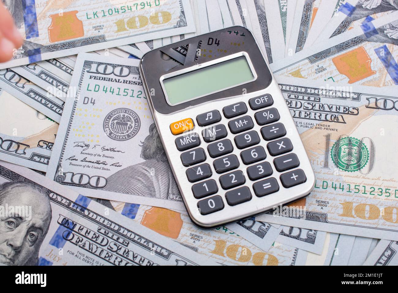 Calculator is placed on the banknote of US dollars spread around Stock ...