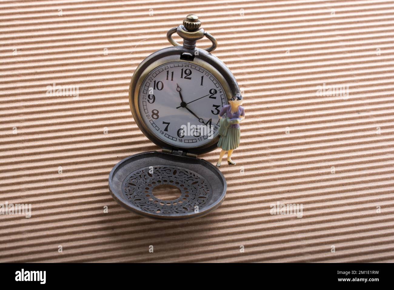 Paper woman shape and a retro pocket watch Stock Photo - Alamy