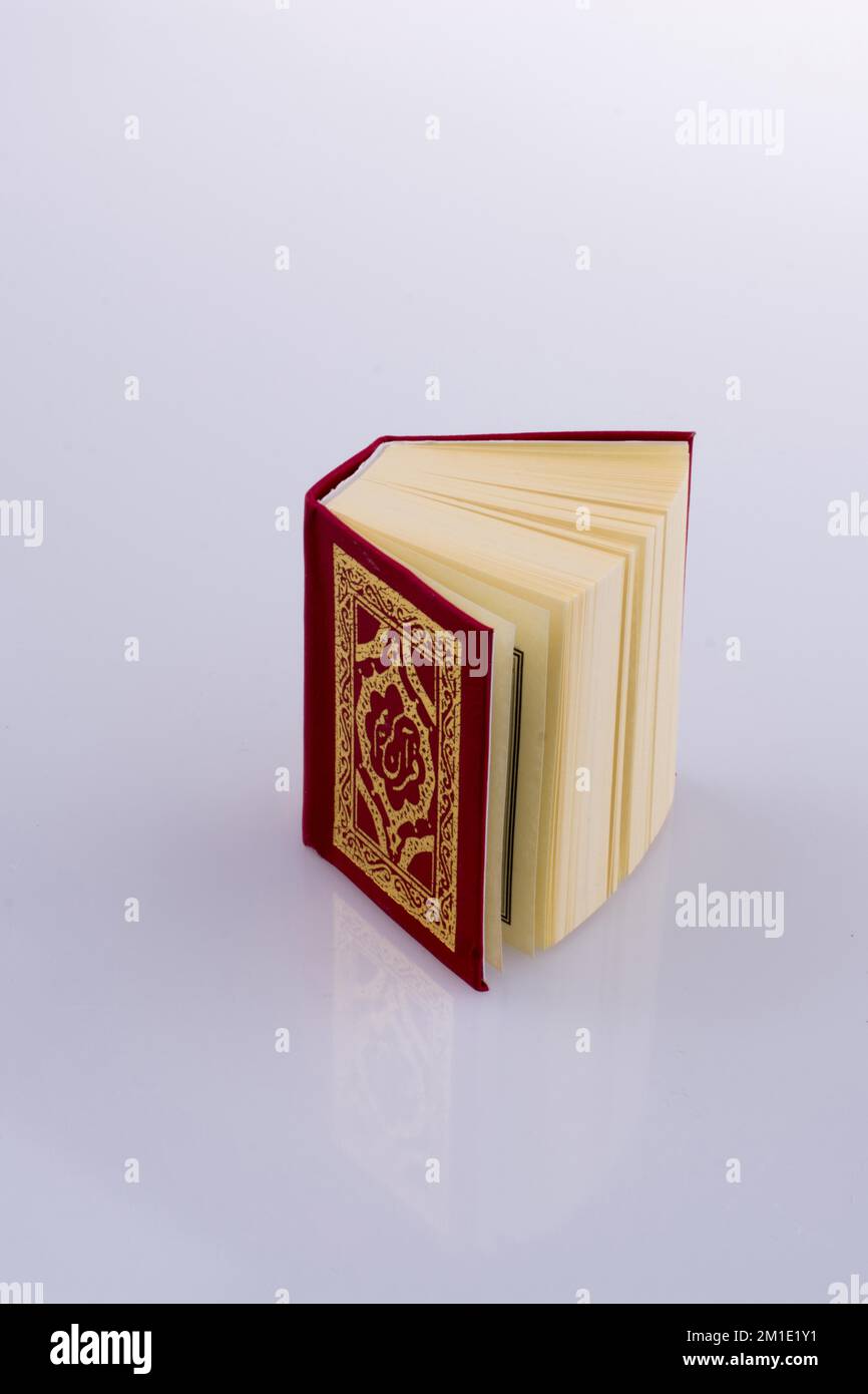 The Holy Quran on a white background Stock Photo - Alamy