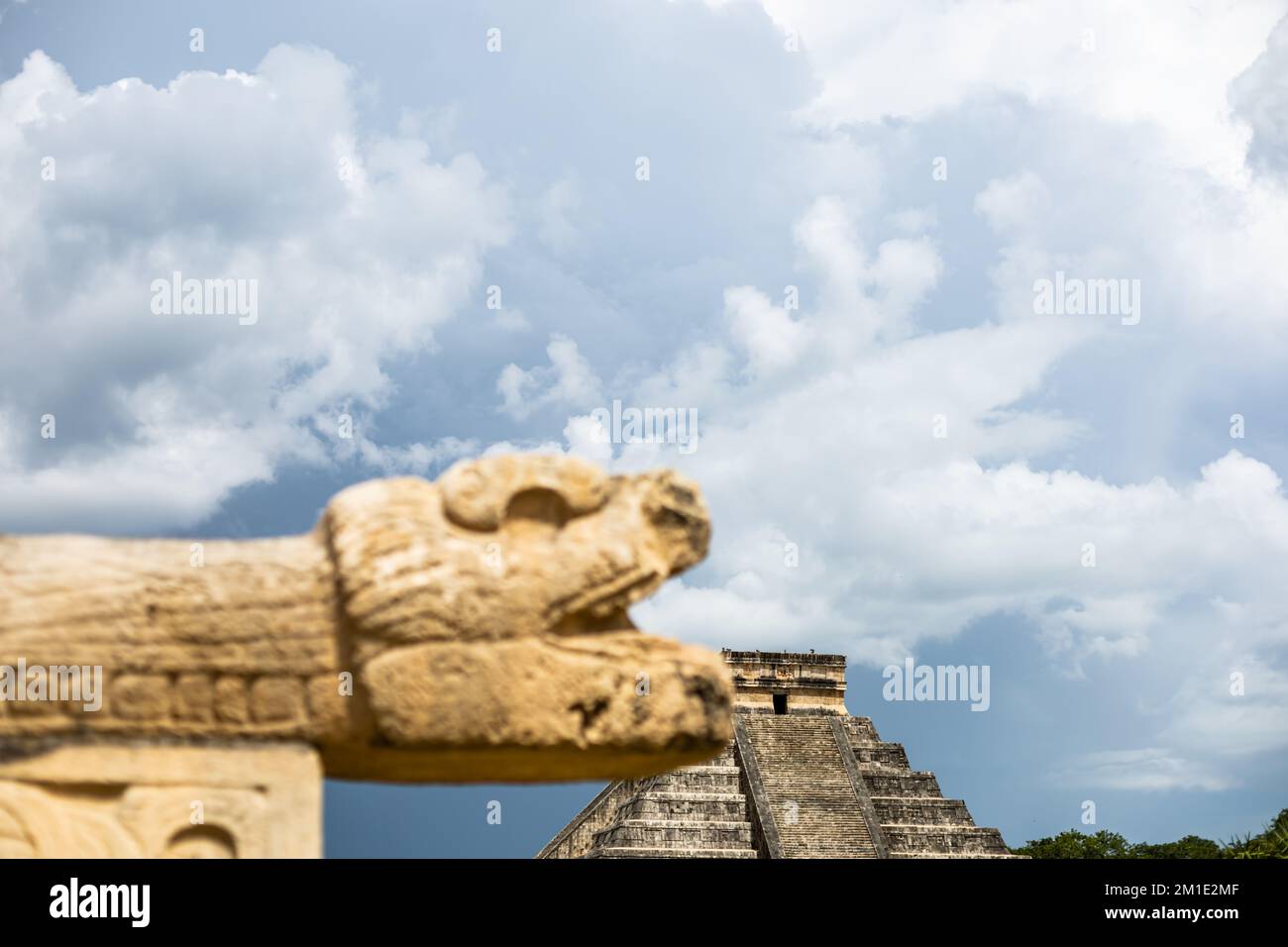 A distant shot of the El Castillo step-pyramid and a piece of Mayan ...