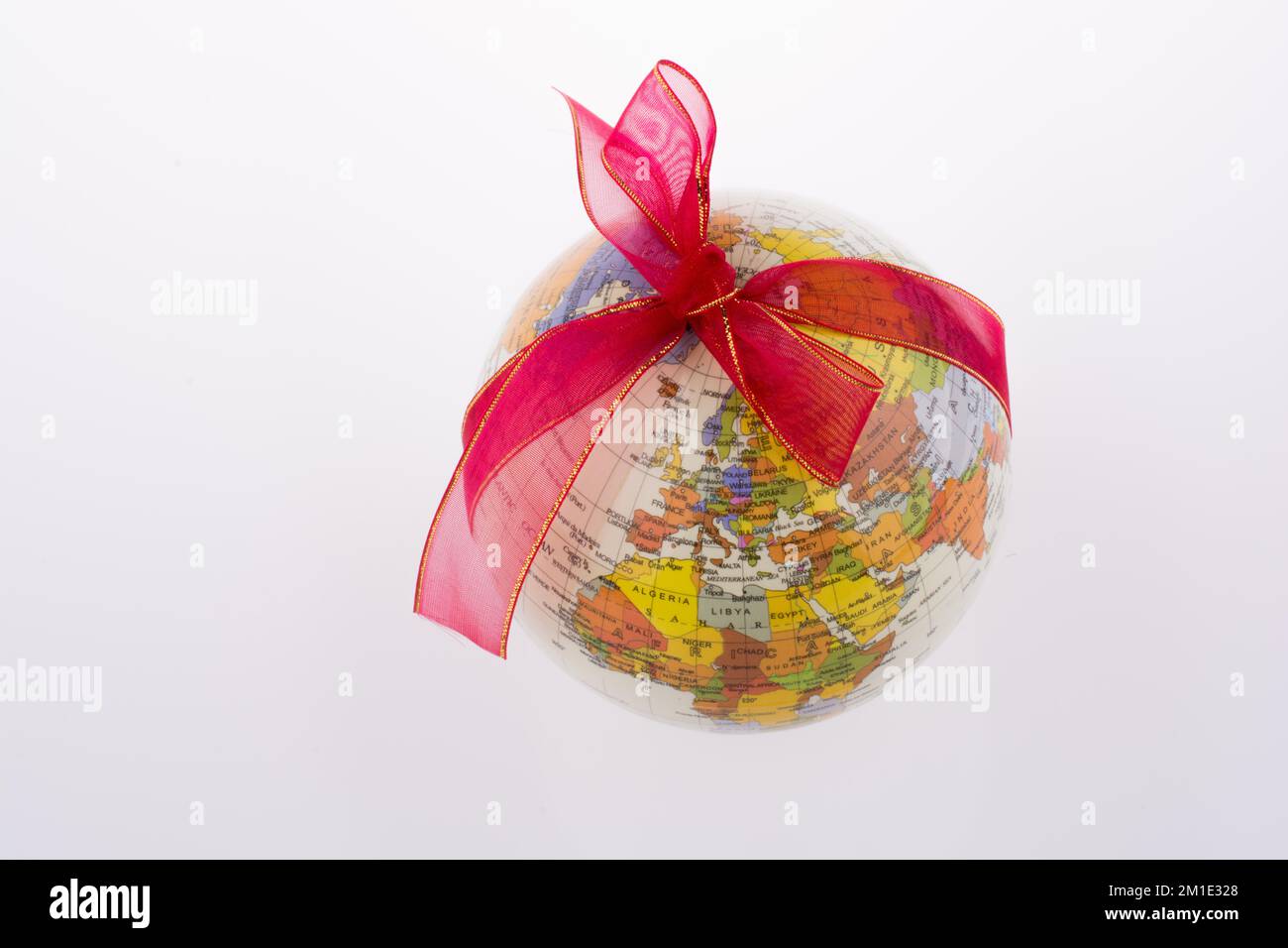 Globe tied red ribbon hi-res stock photography and images - Alamy