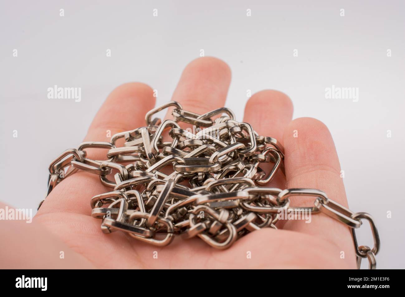 Chain made of gold color in hand Stock Photo - Alamy